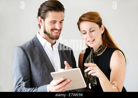 Group of business people discussing work in office building hallway ...