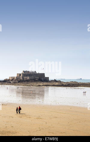 Couple in water of beach of Fort George Cay, an uninhabited island ...
