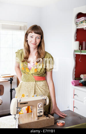 Woman sewing a dress on a sewing machine. Close-up, selective focus ...