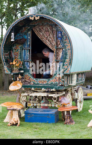 Traditional Romany bow-top Gypsy wagons or Vardos, pause on their ...