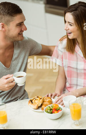 Cute couple having breakfast together in the kitchen Stock Photo - Alamy