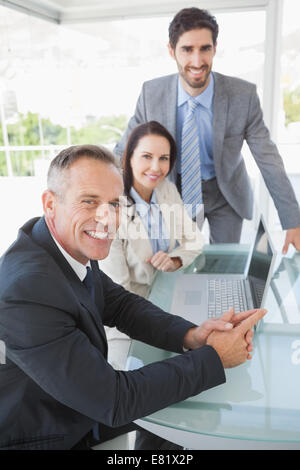 Smiling business people at work Stock Photo - Alamy