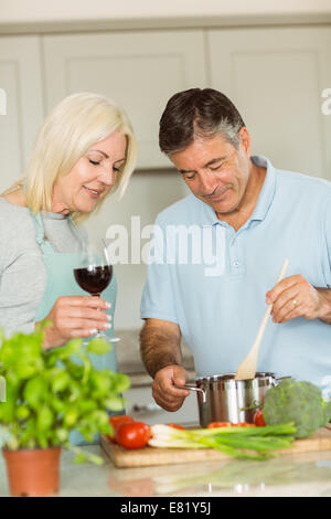 Happy mature couple making dinner together Stock Photo - Alamy
