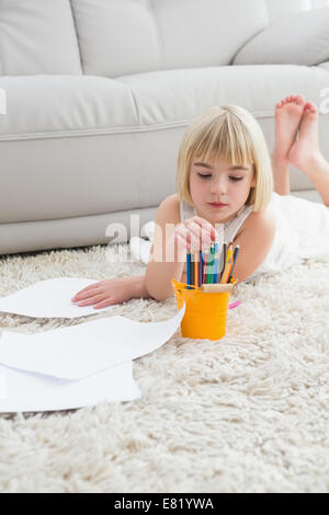 Girl lying on floor drawing picture Stock Photo - Alamy