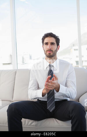 Businessman clapping while sitting down Stock Photo - Alamy