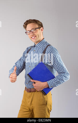 Geeky student holding a notebook Stock Photo - Alamy