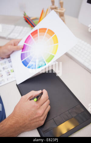 Designer using graphics tablet and colour wheel Stock Photo - Alamy