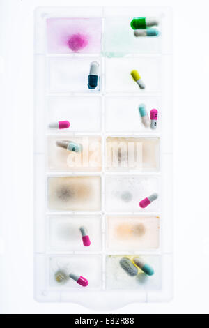 Capsules frozen in a block of ice Stock Photo - Alamy