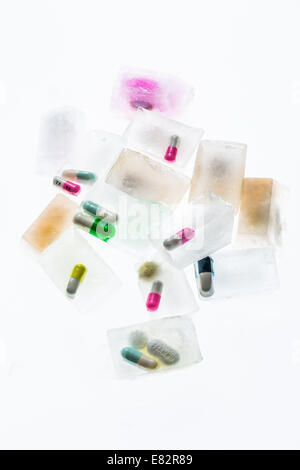Capsules frozen in a block of ice Stock Photo - Alamy