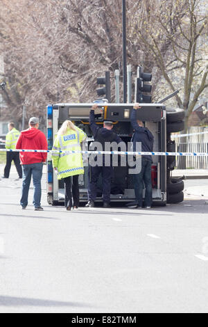 A police riot van flips over on its side after crashing into a ...