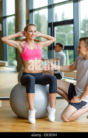 Sporty young man training with fitball at home Stock Photo - Alamy