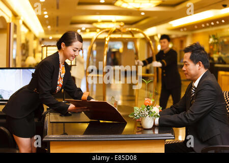 Young businessman at hotel reception Stock Photo - Alamy