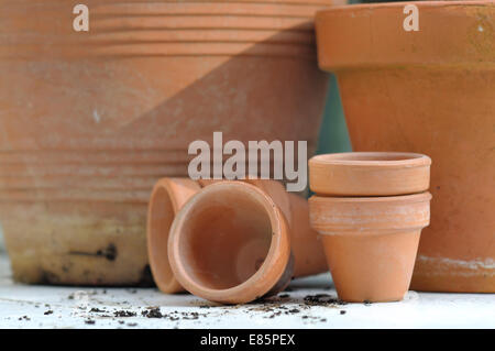 different sizes of terracotta pots on outdoor table Stock Photo - Alamy