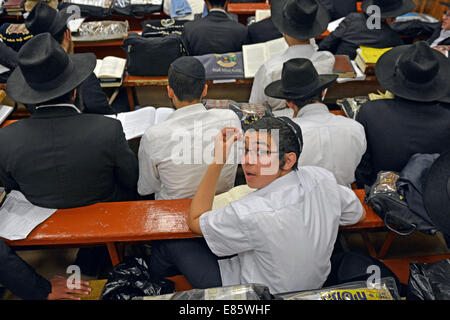 A group of religious Jewish boys studying together at a synagogue in ...