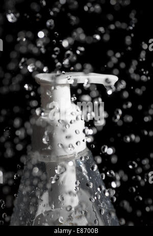 Beauty product tube falling into water with copy space background on ...