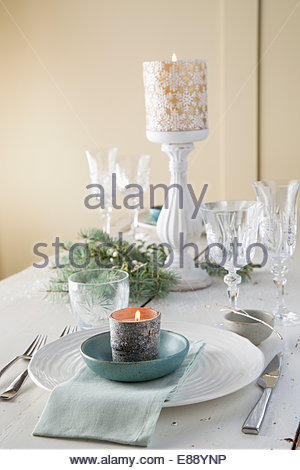 christmas place setting, table ready for lunch, on golden plates and ...