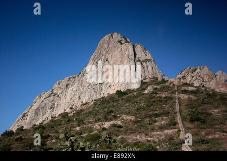 The Pena de Bernal monolithic mountain is seen from a street of San ...