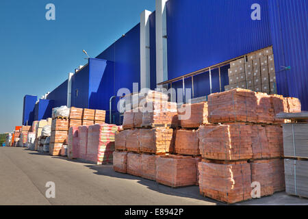 A pile of building materials near the warehouse Stock Photo - Alamy