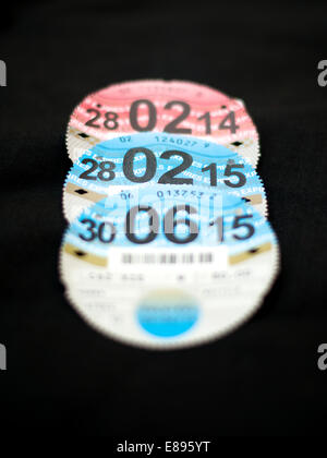 Three UK car tax discs dating in different colours Stock Photo - Alamy