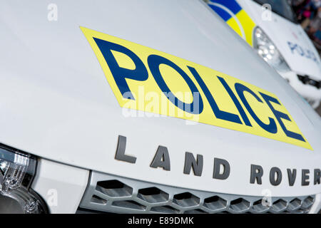 The word police on a sign on the hood of a white British Vauxhall ...