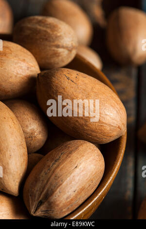 Pecans, raw pecan nut halves in a wooden bowl. Shelled seeds. Pecan ...