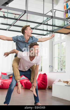 Young homosexual couple standing over white background skeptic and ...