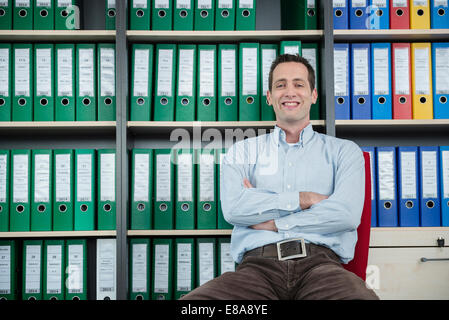 Man office sorting filing cabinet organizing Stock Photo - Alamy