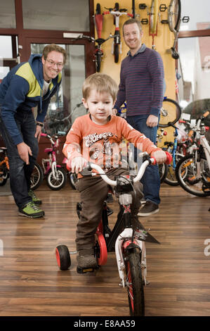 Boy getting a new children's bike Stock Photo - Alamy