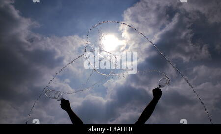 Man throwing water from a wine glass Stock Photo - Alamy