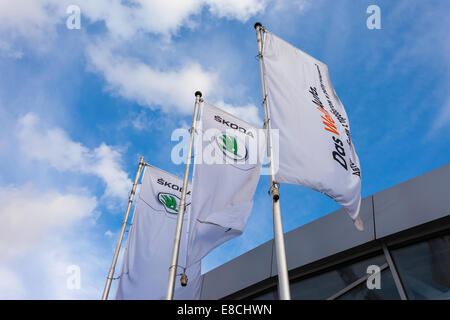 The flags of Skoda over blue sky. Skoda Auto more commonly known as ...