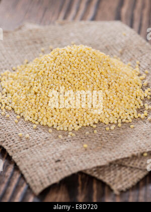 Heap of Millet on a dark vintage wooden table Stock Photo - Alamy