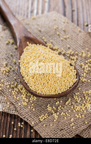 Heap of Millet on a dark vintage wooden table Stock Photo - Alamy