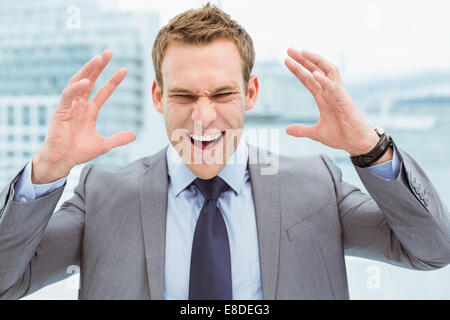 Angry young businessman at office Stock Photo - Alamy