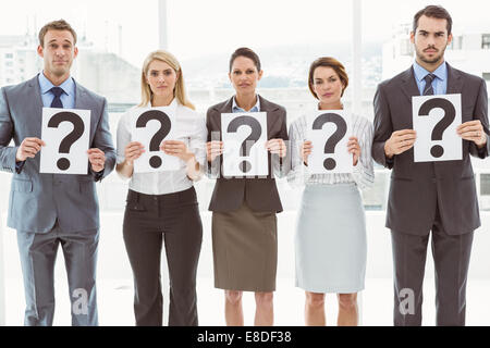 Business people holding question mark signs Stock Photo - Alamy