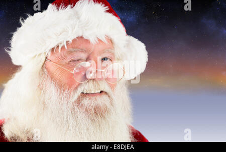 Composite image of santa claus winking Stock Photo - Alamy