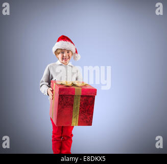 Composite image of festive boy holding a gift Stock Photo - Alamy