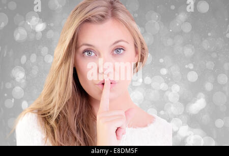 Composite image of pretty blonde keeping a secret holding bags Stock ...