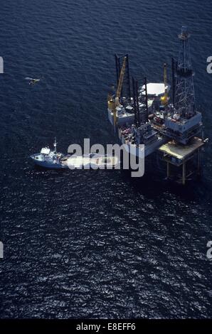 Offshore oil rig with supply boat and workers at Huntington Beach ...