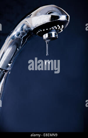 Water drop leaking of a broken tap. Bathroom water leak, corrosion ...