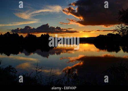 SUNSET OVER LAND Stock Photo - Alamy