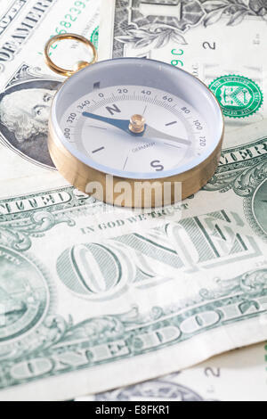 Dollars and compass Stock Photo - Alamy