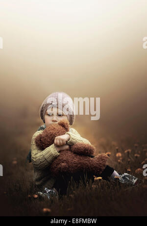girl cuddling teddy Stock Photo - Alamy