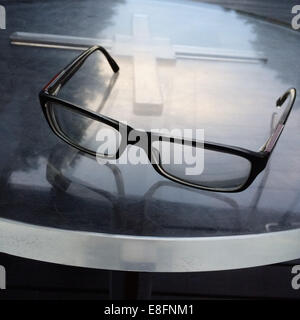Eyeglasses on table Stock Photo - Alamy