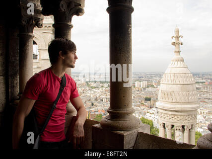 Young caucasian man standing over bricks wall smiling with happy face ...