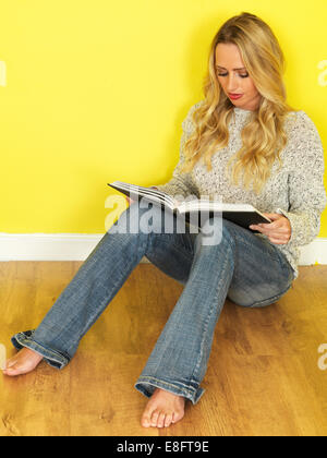 Young blonde woman wearing student backpack and holding books smiling ...