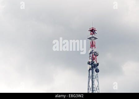 Red and white communication tower with GSM antenna transmitters Stock Photo - Alamy