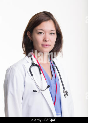 Young Asian woman doctor in blue scrubs talking on smartphone at modern ...