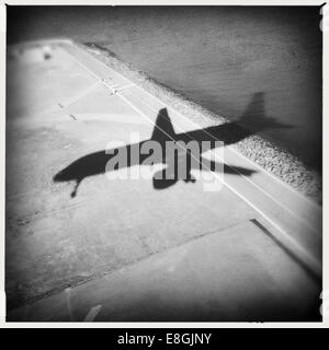 Shadow of a flying airplane taking off Stock Photo - Alamy