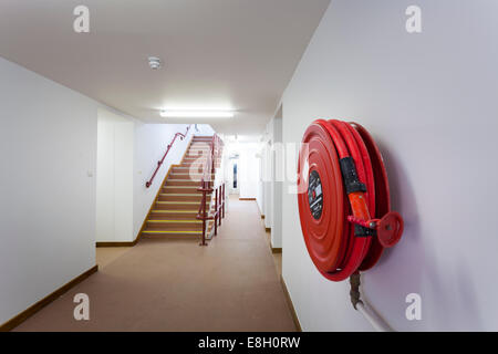 Fire hose in corridor Stock Photo - Alamy