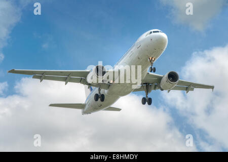Jet plane landing with cloudy sky at background Stock Photo - Alamy
